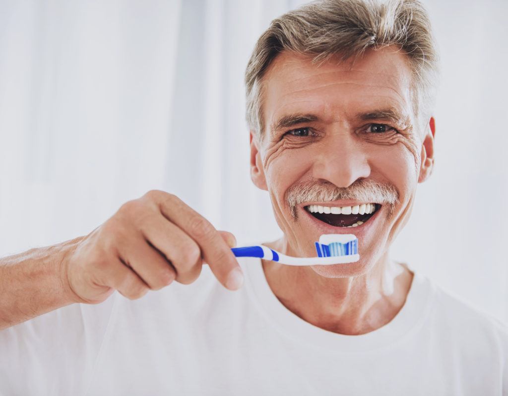 Close Up. Senior Man Brushing Teeth In Bathroom. Morning Routine - Dr ...